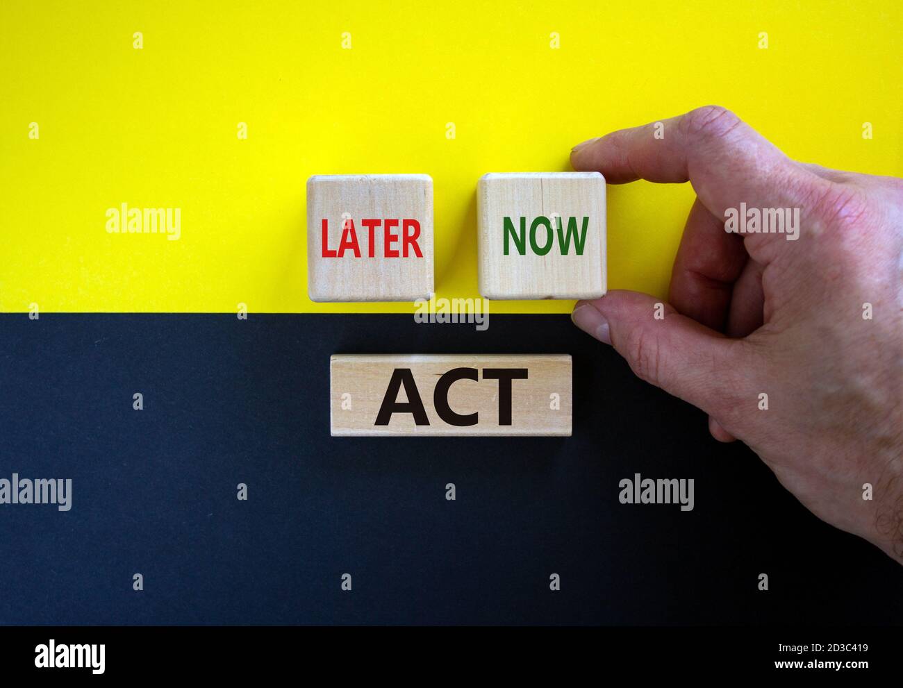 Act now or later. Businessman holds a cubes with word 'now'. Wooden ...