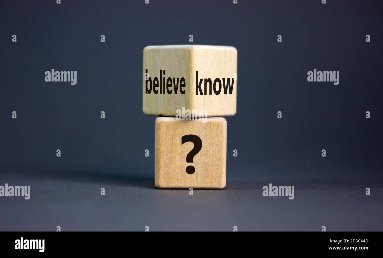 Conflict of knowing or believing. Wooden cubes with words 'believe' and ...