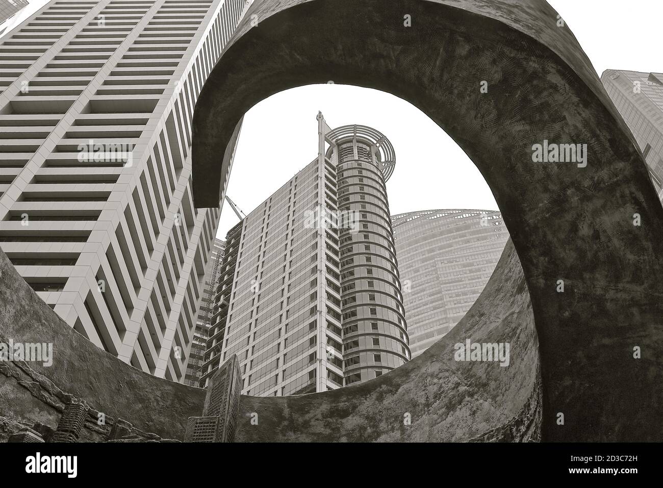 An upward view of a cityscape framed through an elliptical shaped ...