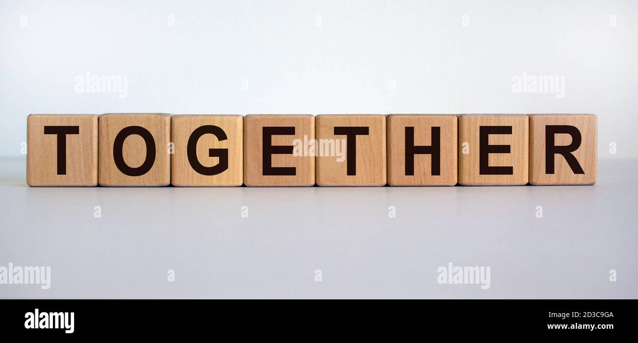 Wooden cubes form the words 'together' on beautiful white background ...