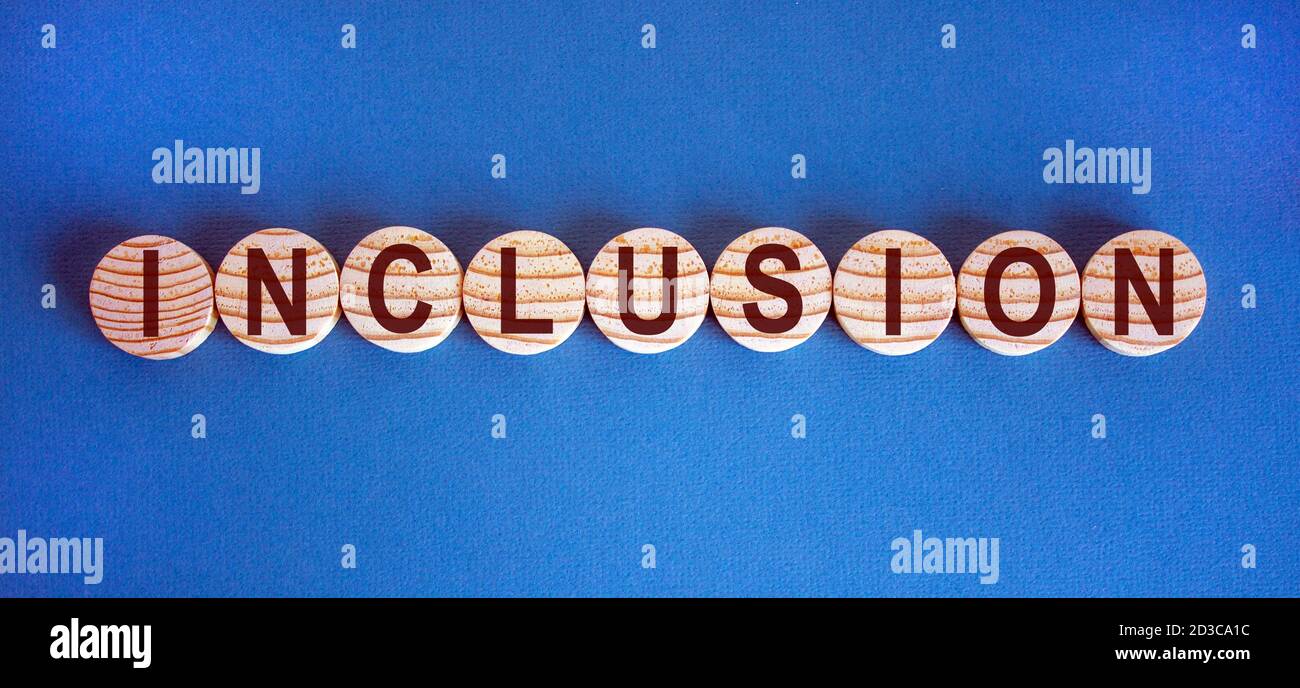 Symbol for a better inclusion. Wooden circles with word 'inclusion ...