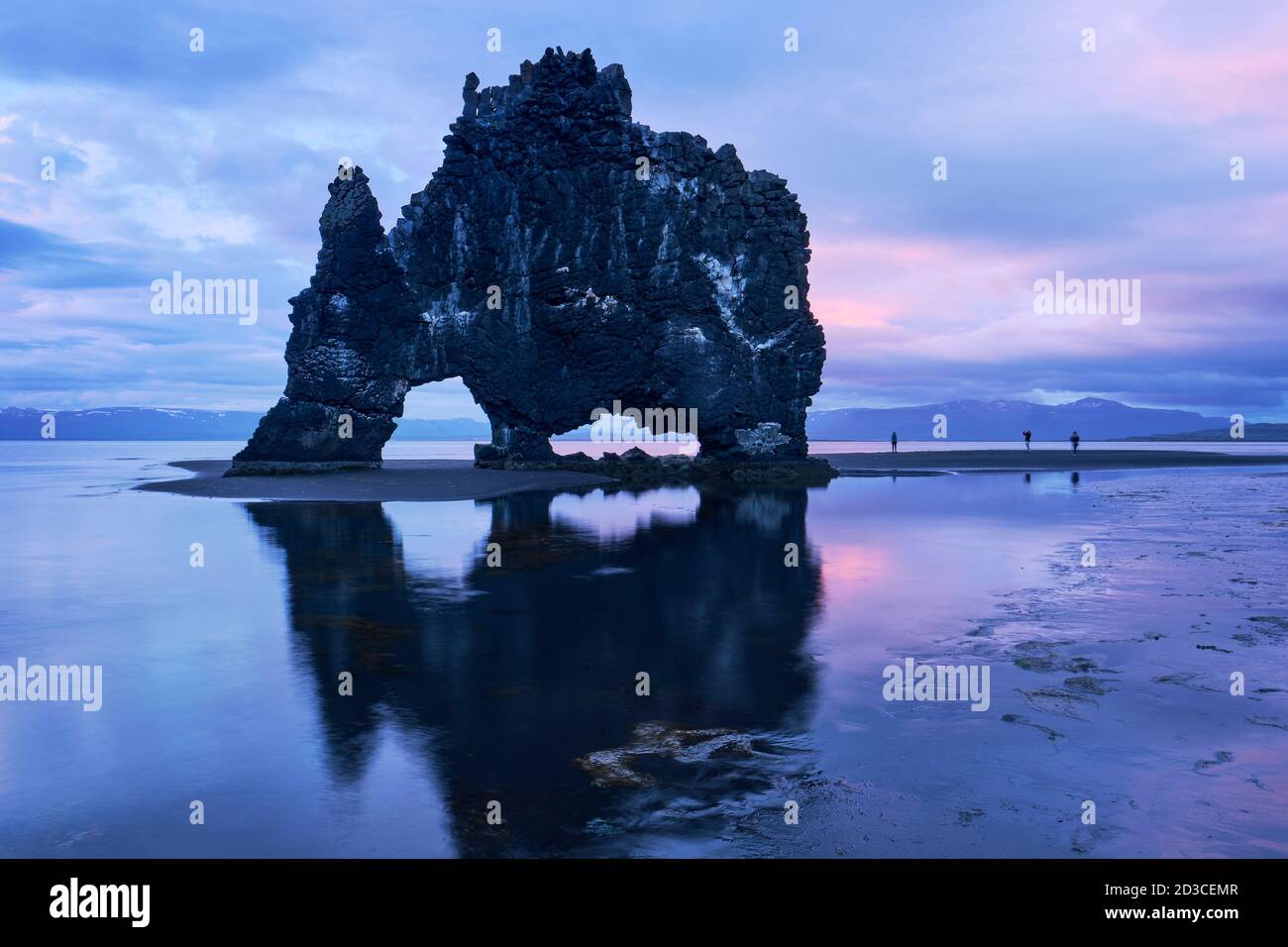 Tourists visiting Hvítserkur a 15m high basalt stack along the eastern ...