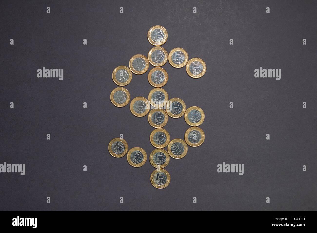 Dollar sign made by shiny silver coins with golden edges on black ...