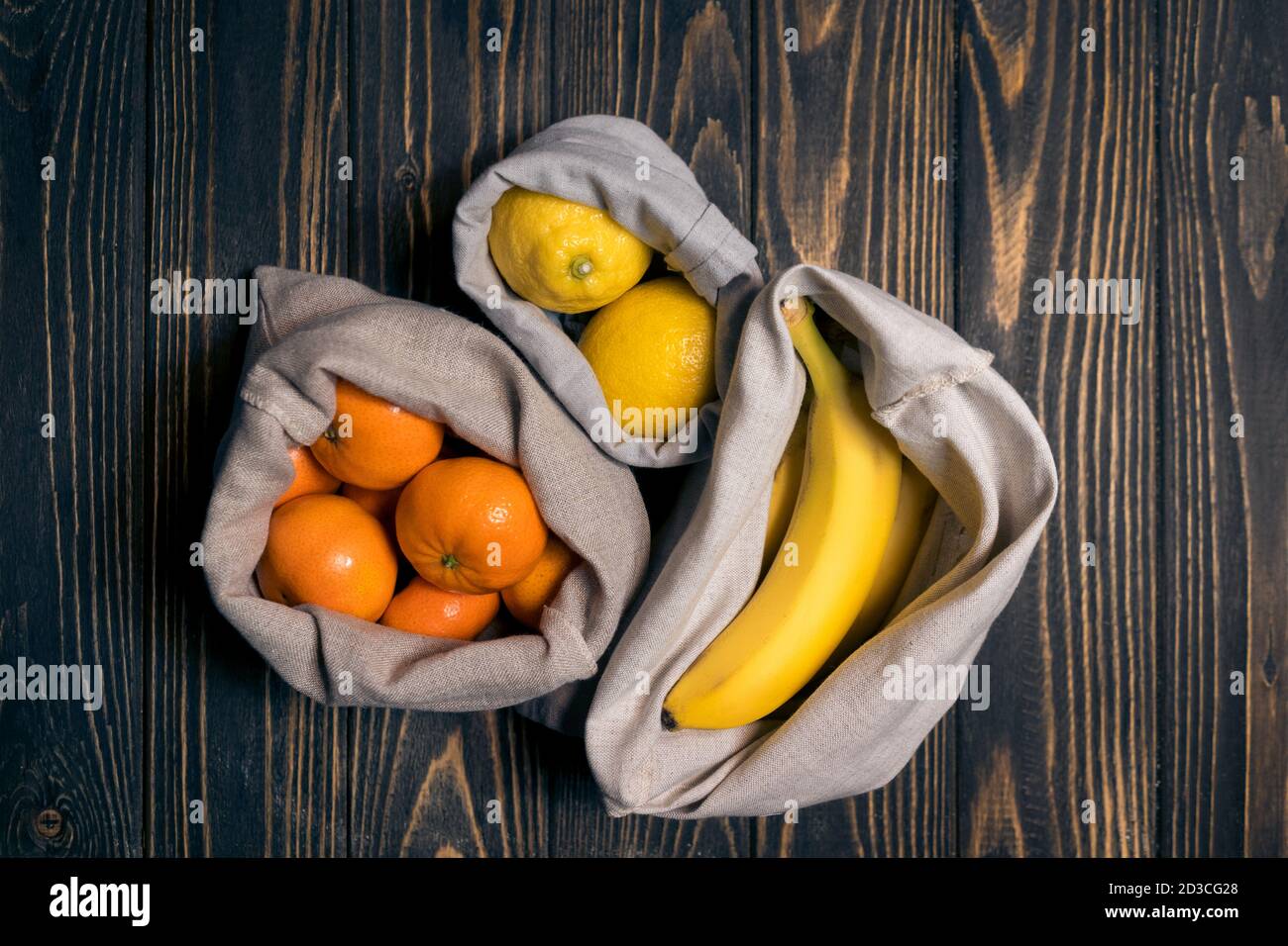 fresh fruits in recyclable eco bags on wooden table, top view Stock ...