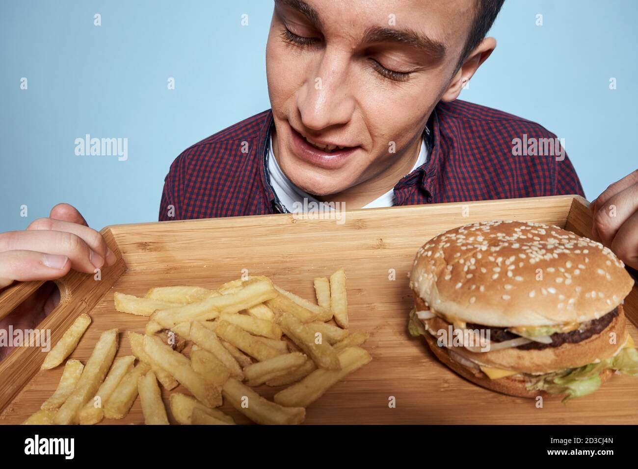 Man with wooden pallet fast food french fries hamburger hunger diet ...