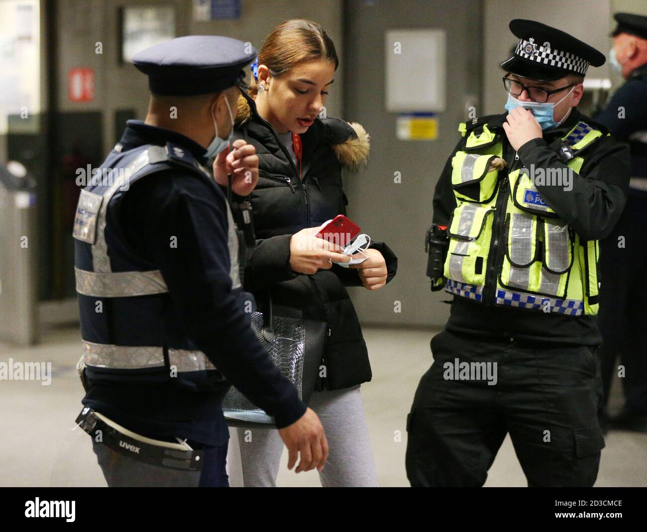 A woman is asked to wear her face mask by a TfL Transport Support and ...