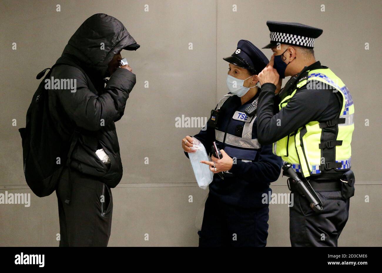 A man is given a face mask to wear after being issued with a fine for ...