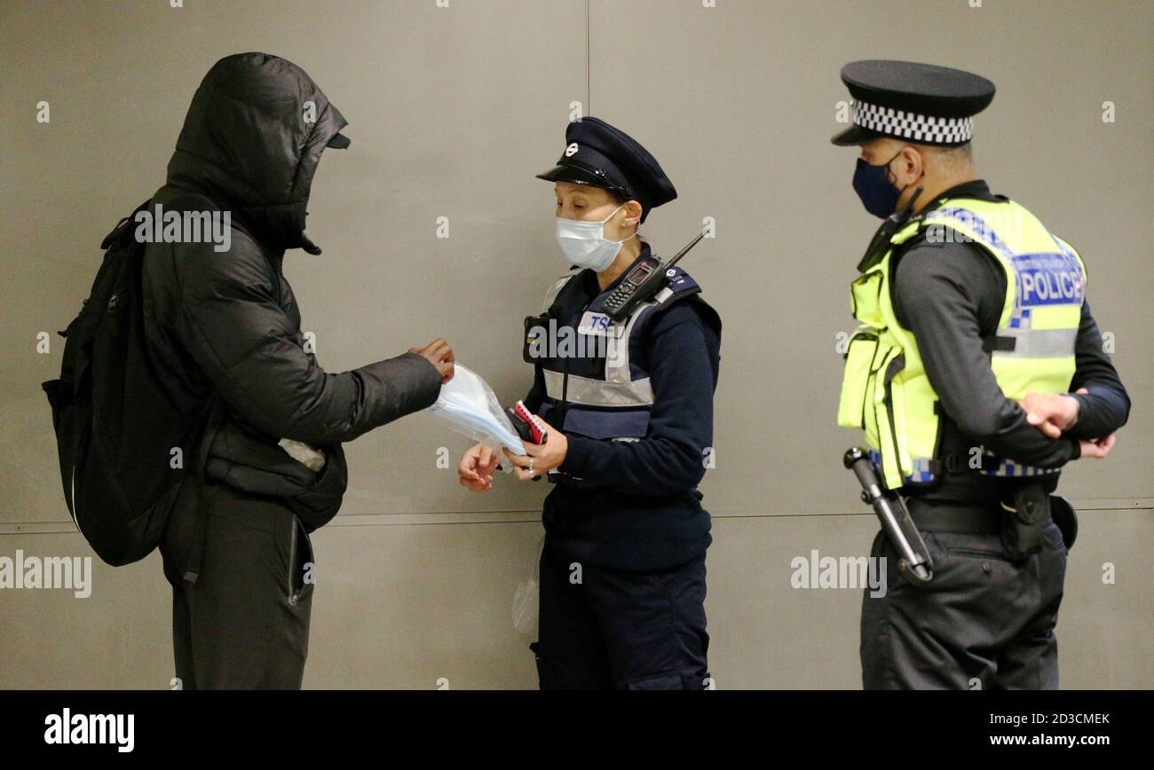 A man is given a face mask to wear after being issued with a fine for ...