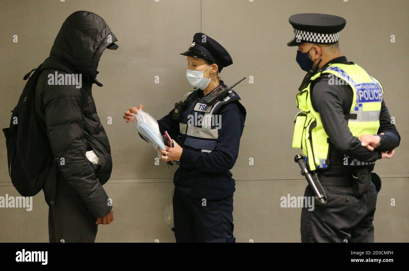A man is given a face mask to wear after being issued with a fine for ...