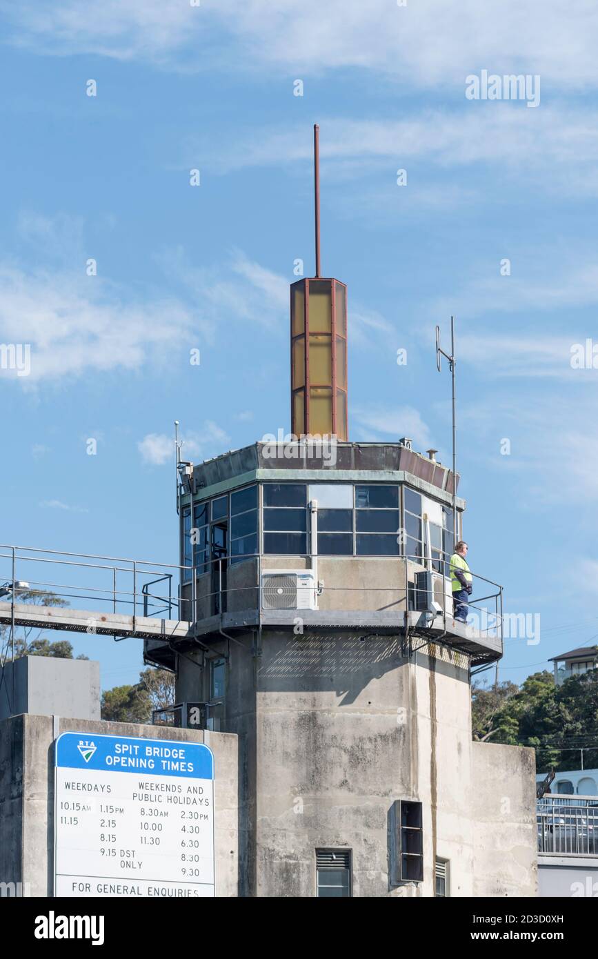 A man stands outside the control room near the lifting section of the ...