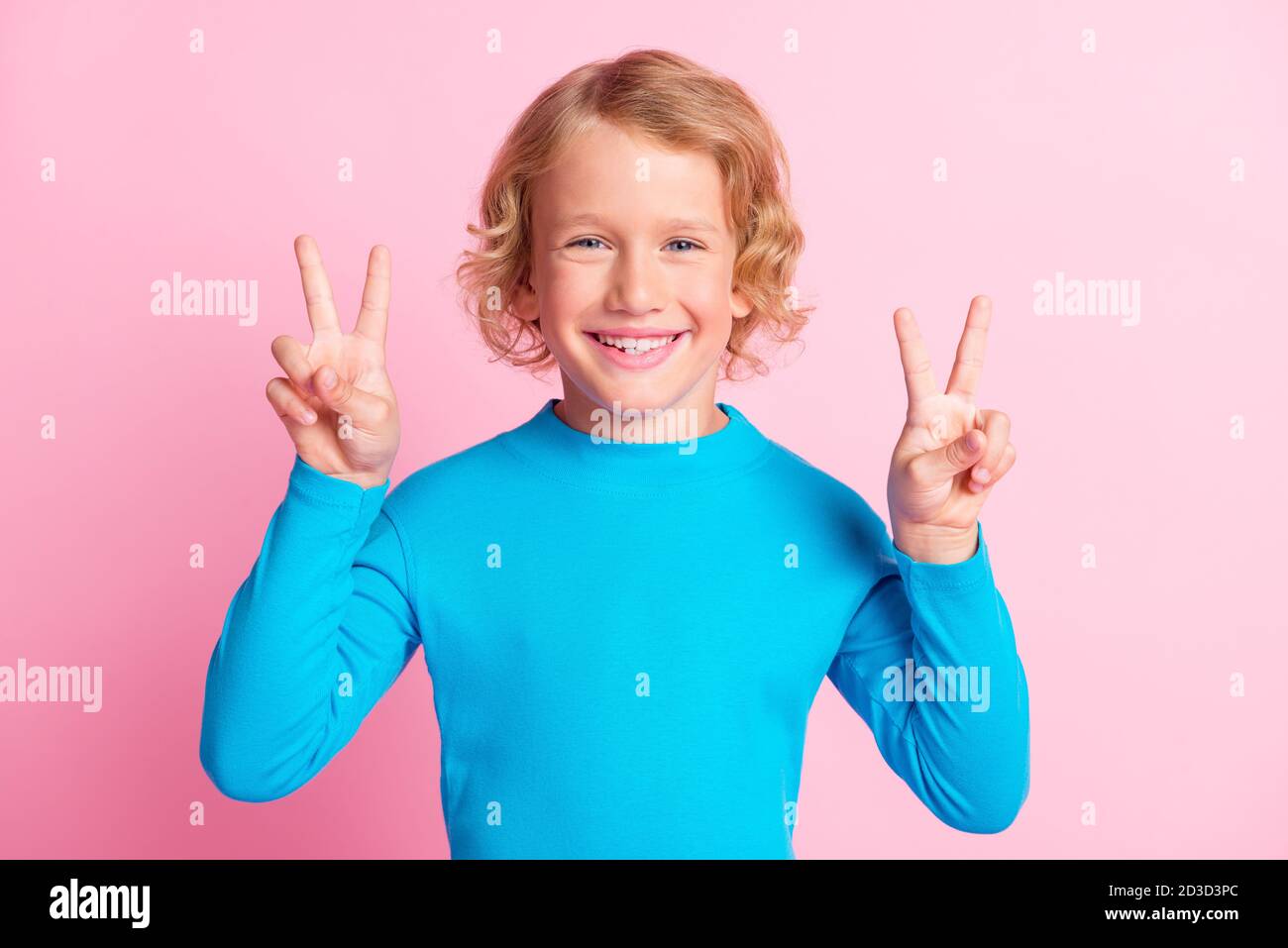 Photo of young little boy raise two hands show v-sign beaming smile ...