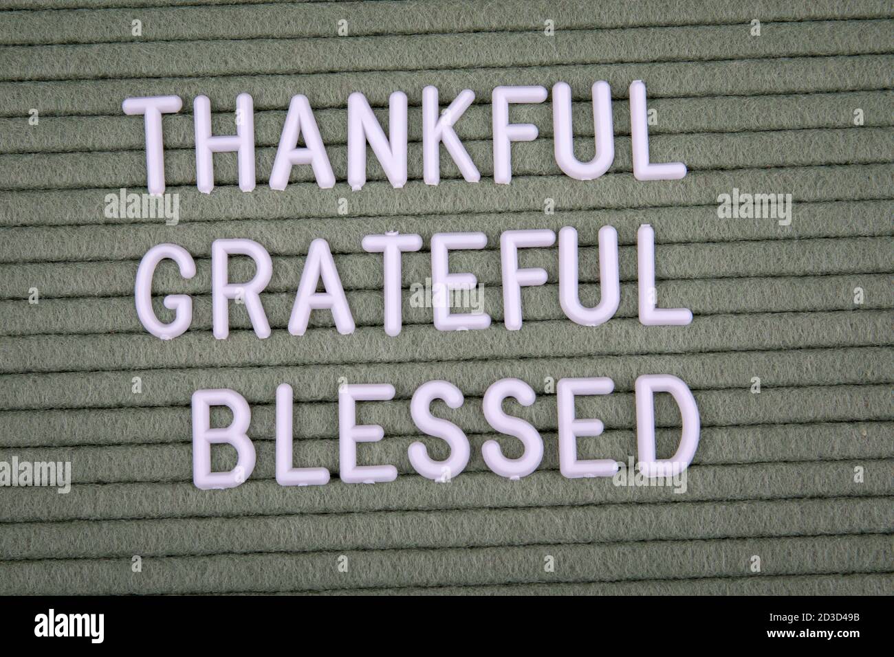 THANKFUL, GRATEFUL and BLESSED. White letters of the alphabet on a ...