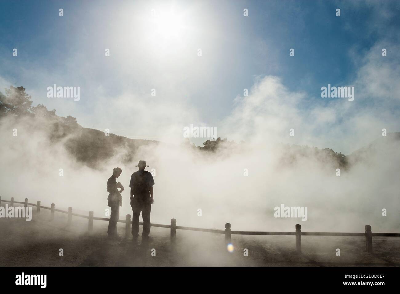 Two people in rising mist at a thermal pool site Stock Photo - Alamy