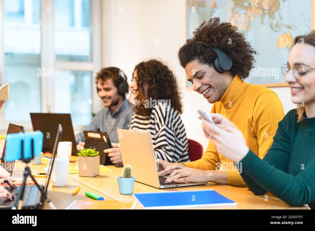 Young friends working together inside co-working creative space ...
