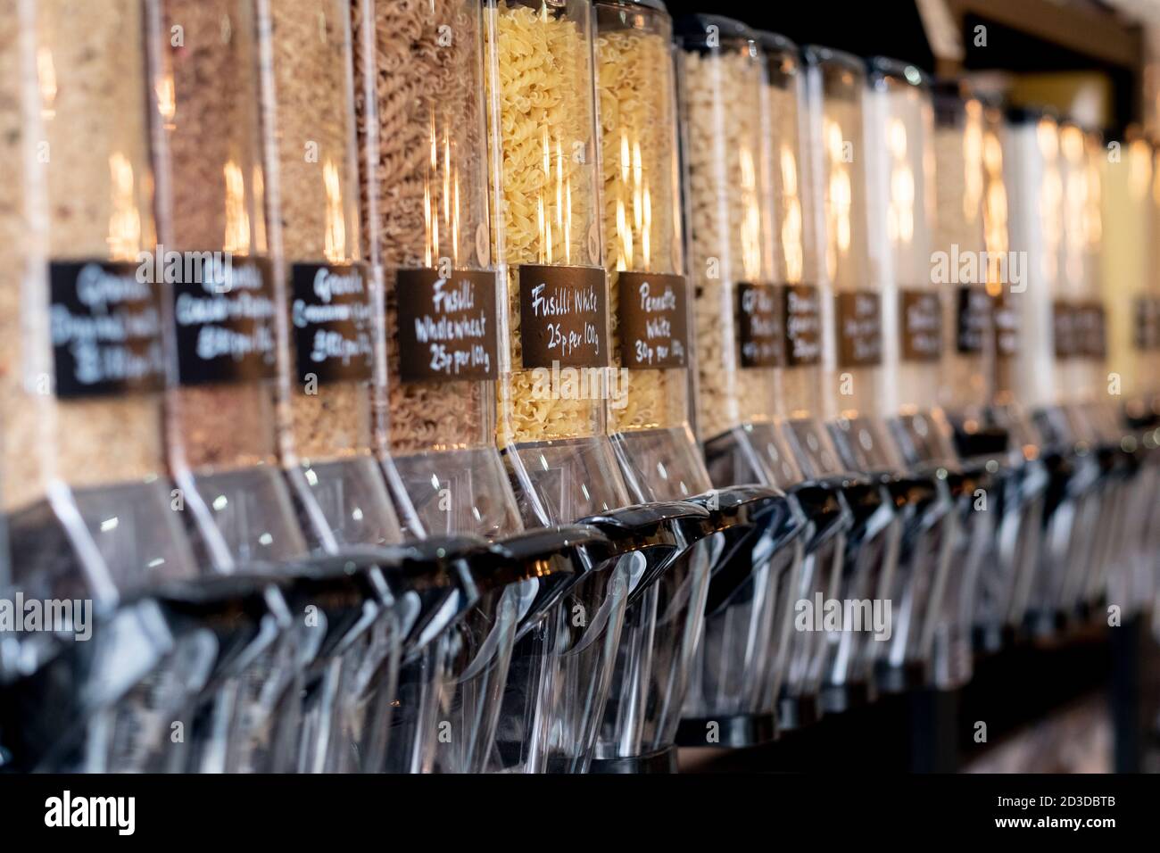Close up of food dispensers with dried pasta in a waste free wholefood ...