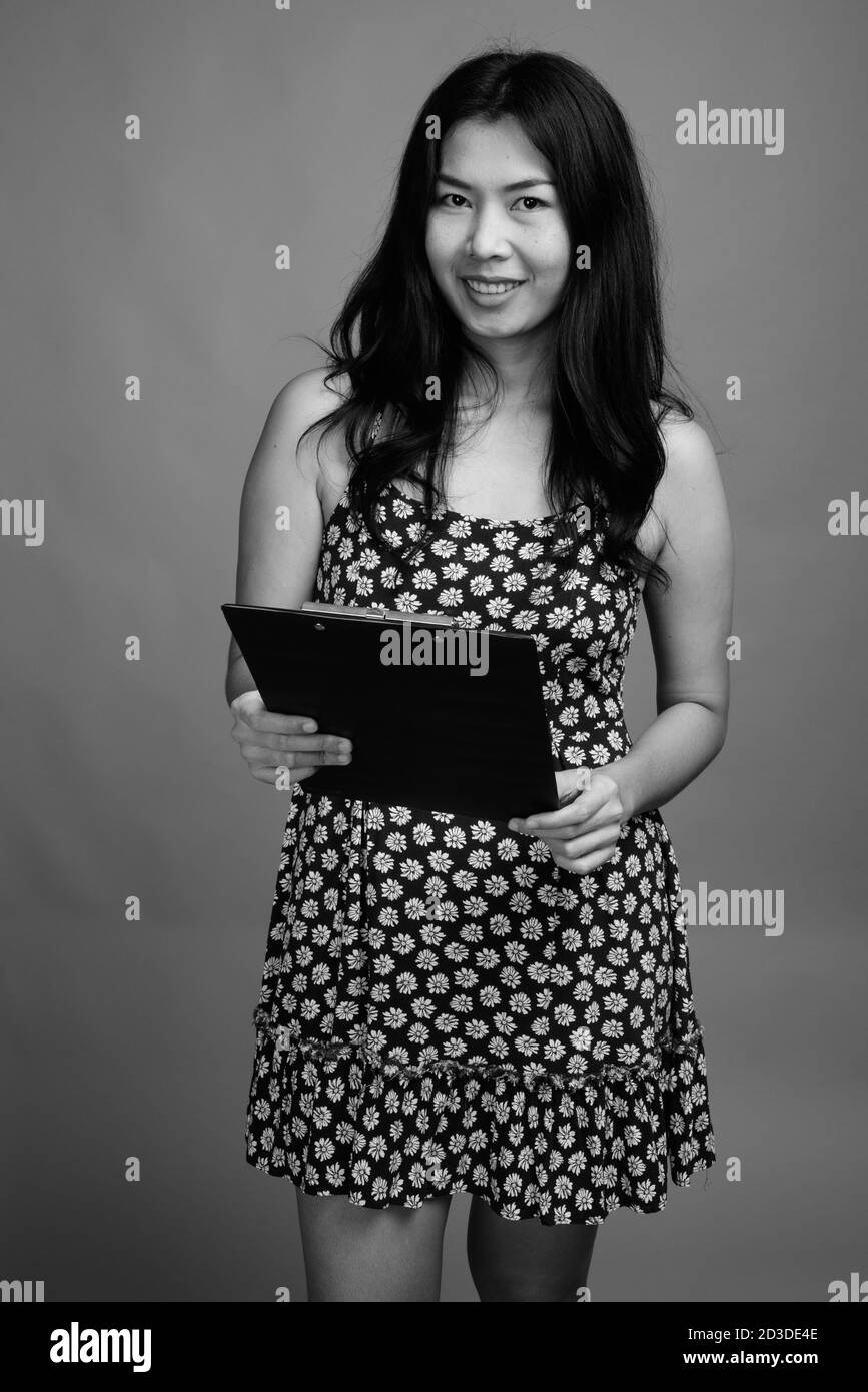 Smiling woman holding clipboard Black and White Stock Photos & Images ...