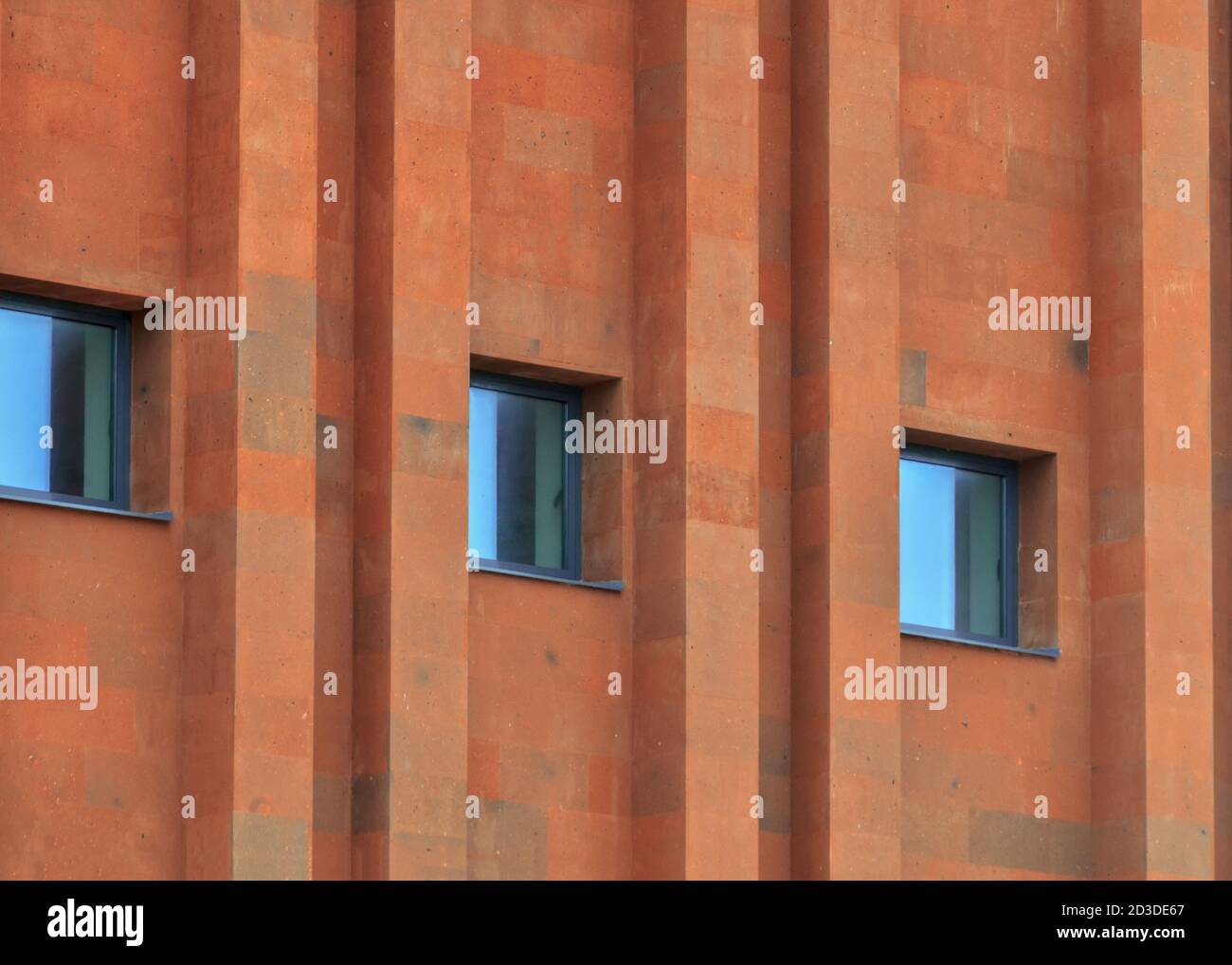 Texture of terracotta brick wall with parallel pattern and windows ...