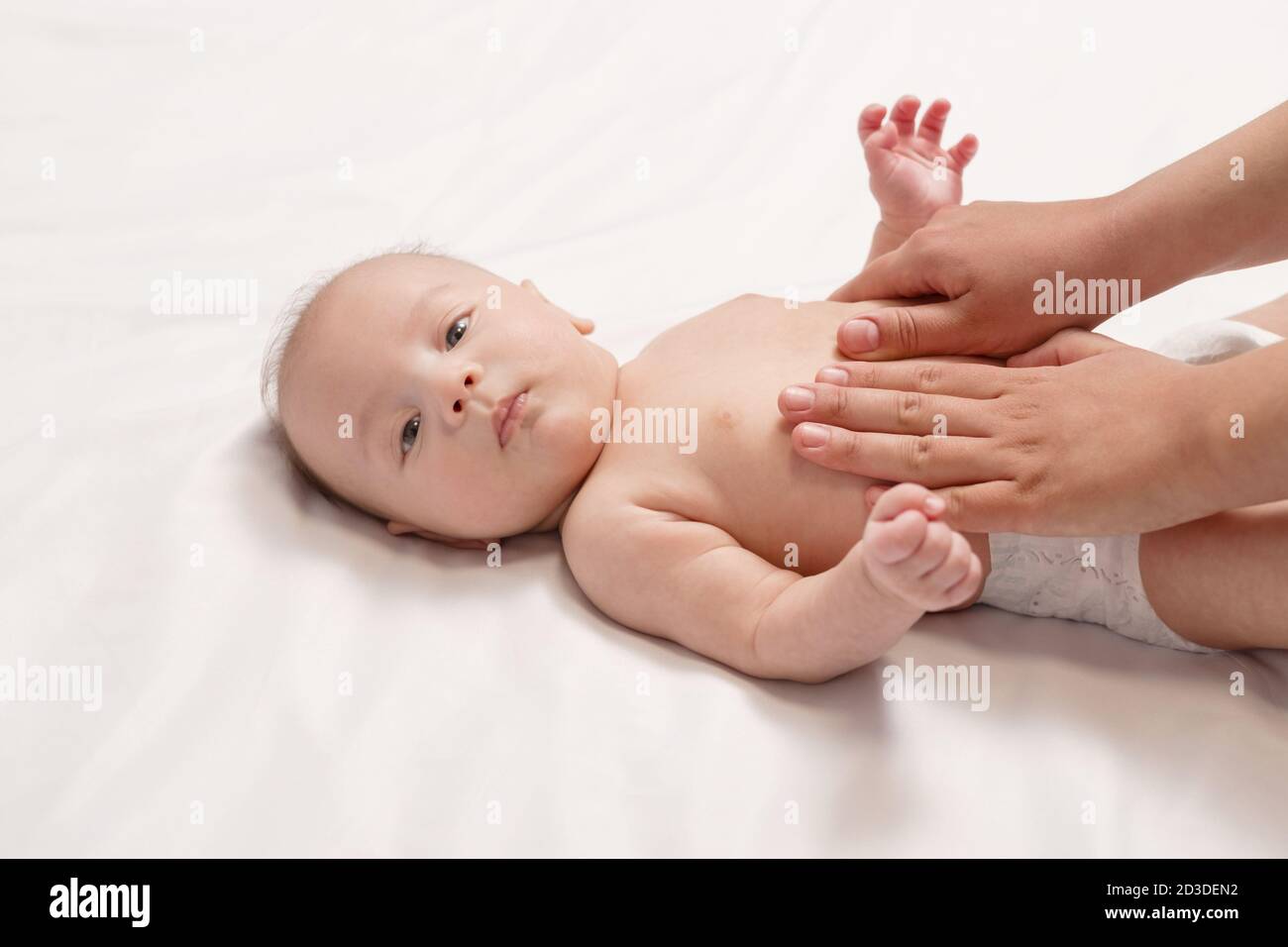 Baby massage hi-res stock photography and images - Alamy