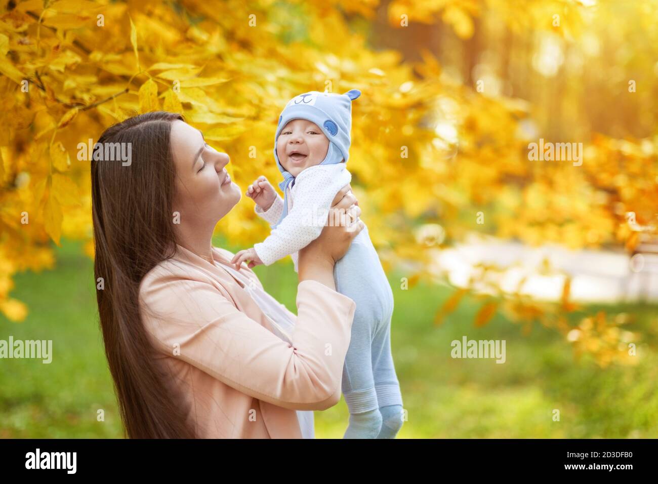 portraits of mom and baby in autumn park Stock Photo - Alamy