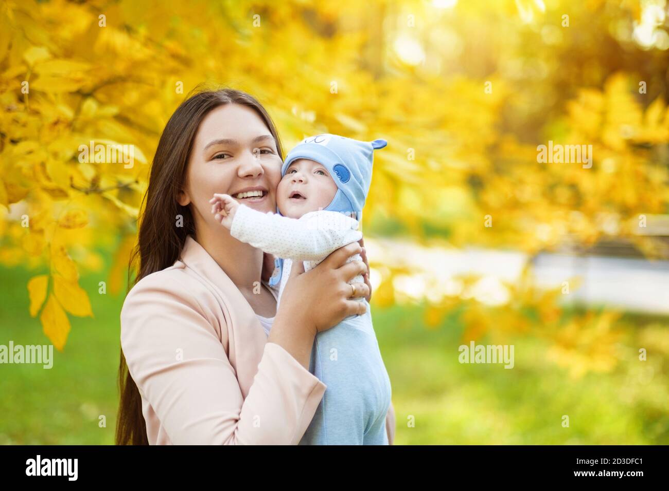 portraits of mom and baby in autumn park Stock Photo - Alamy