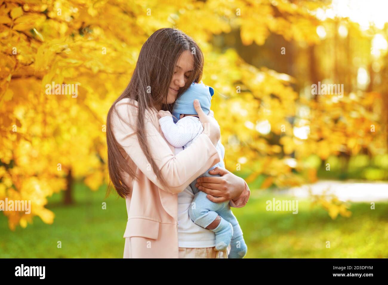 portraits of mom and baby in autumn park, mom hugs baby Stock Photo - Alamy