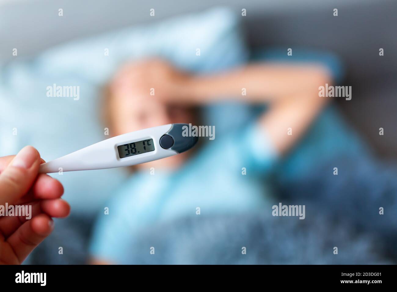 Sick teenage little girl with high fever and headache laying in bed ...