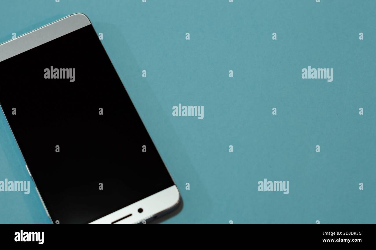 Smart phone on blue background copy space Stock Photo - Alamy