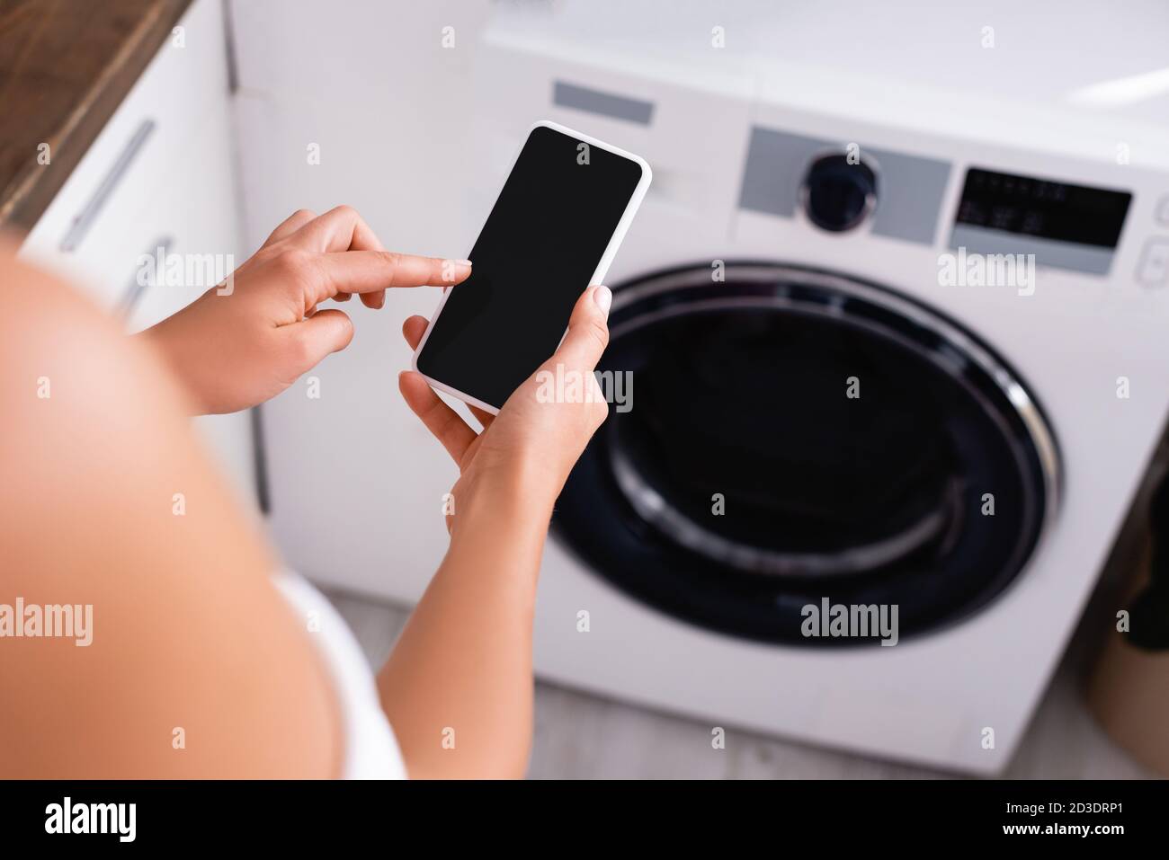 Woman using washing machine hi-res stock photography and images - Alamy