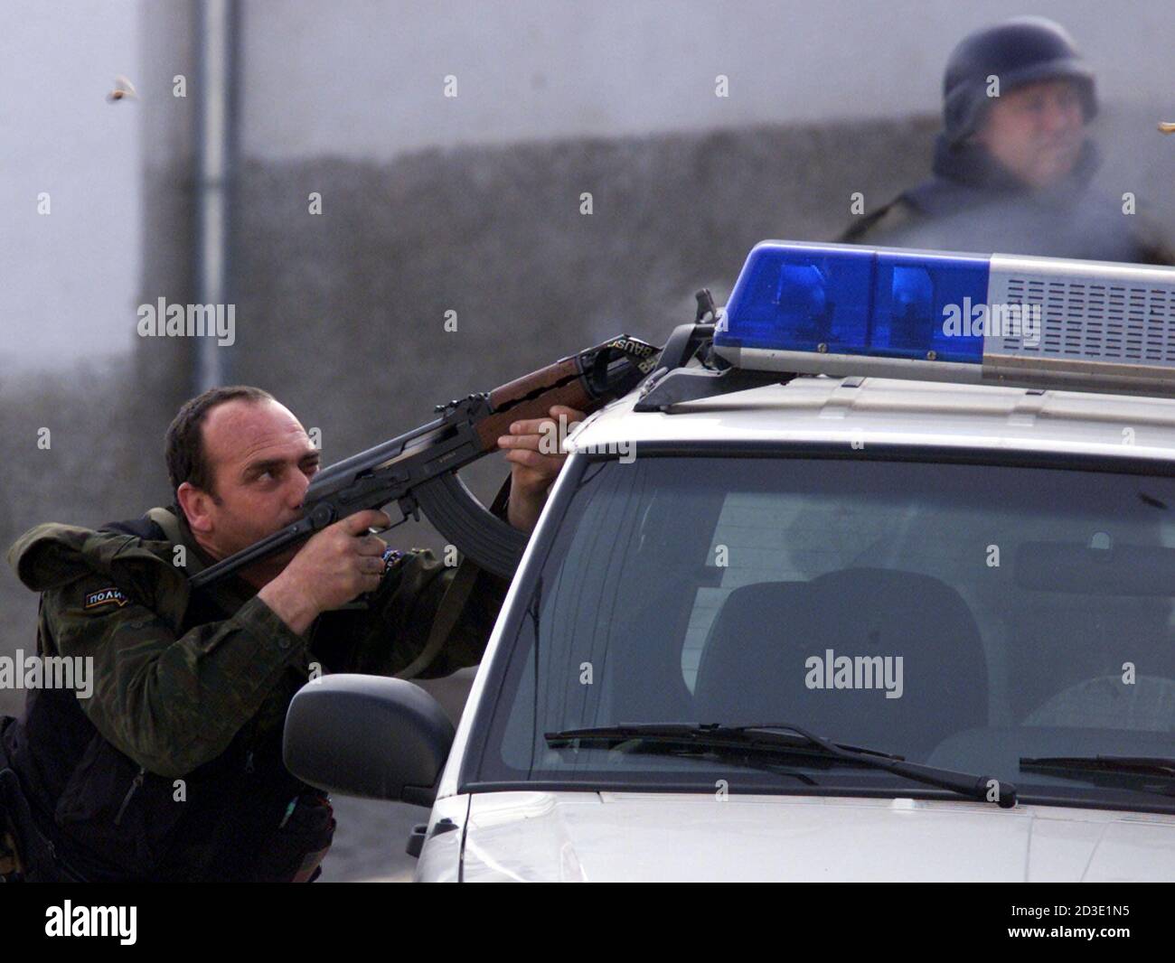 Macedonian policeman fires with his Kalashnikov rifle in Tetovo, some ...
