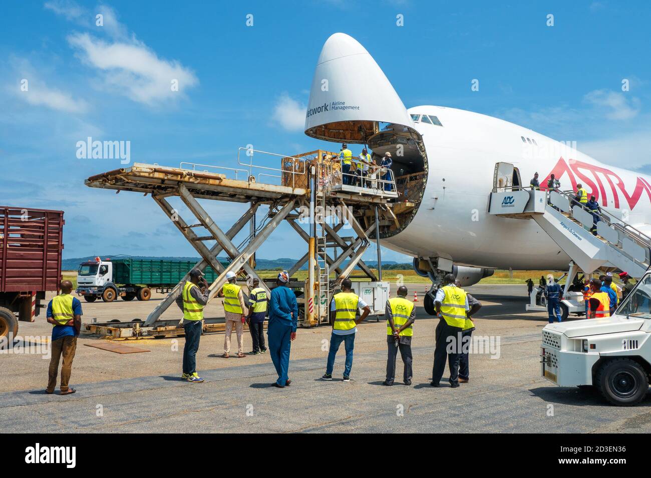 Livestock in wooden boxes being offloaded by a high-loader from a Jumbo ...