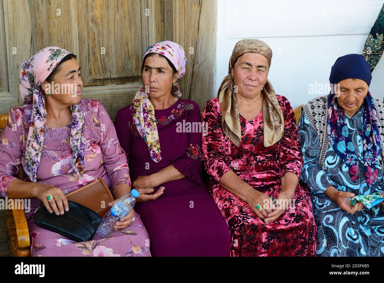 Four, local women sitting on a bench in Bukhara, Uzbekistan Stock Photo ...