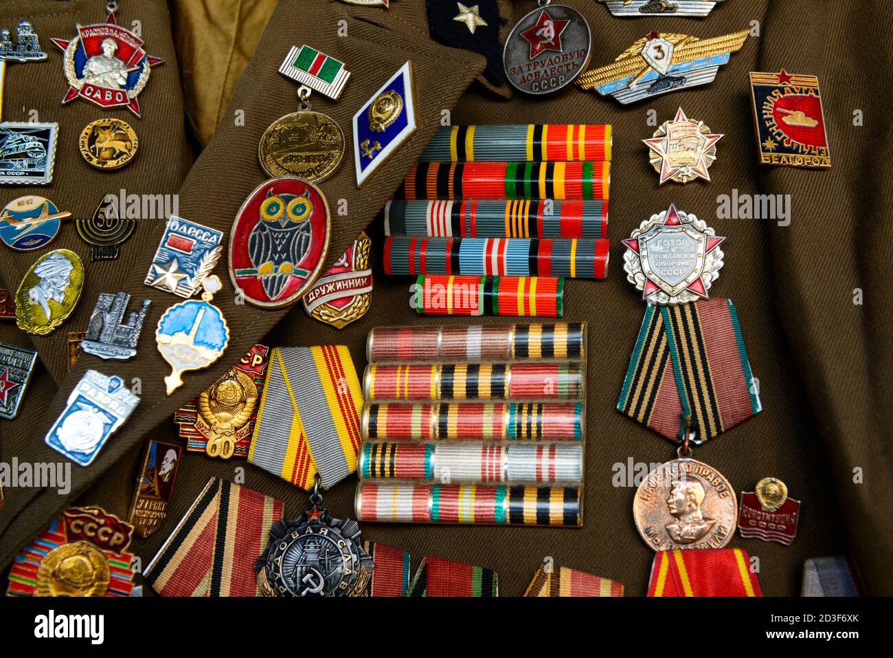 Soviet decorations and badges pinned on a military uniform, sold as ...