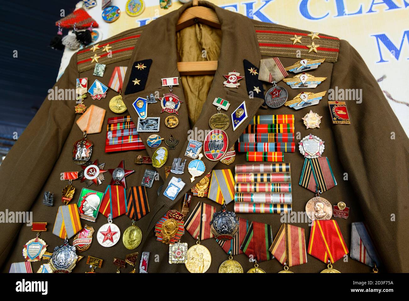 Soviet decorations and badges pinned on a military uniform, sold as ...