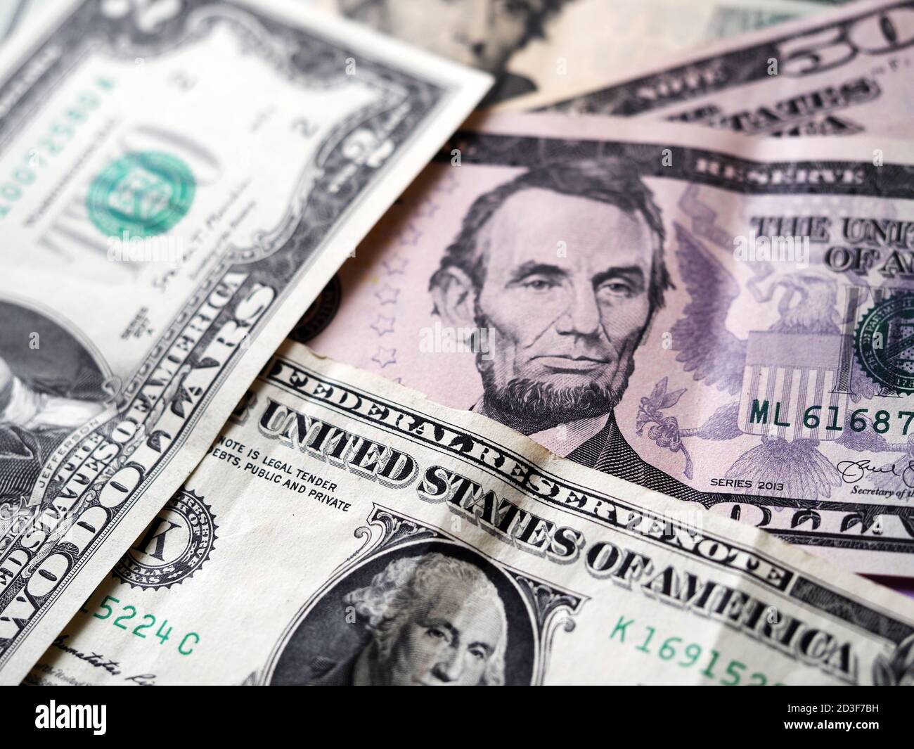 A photo illustration of US various dollar bills ibackground. Selective ...