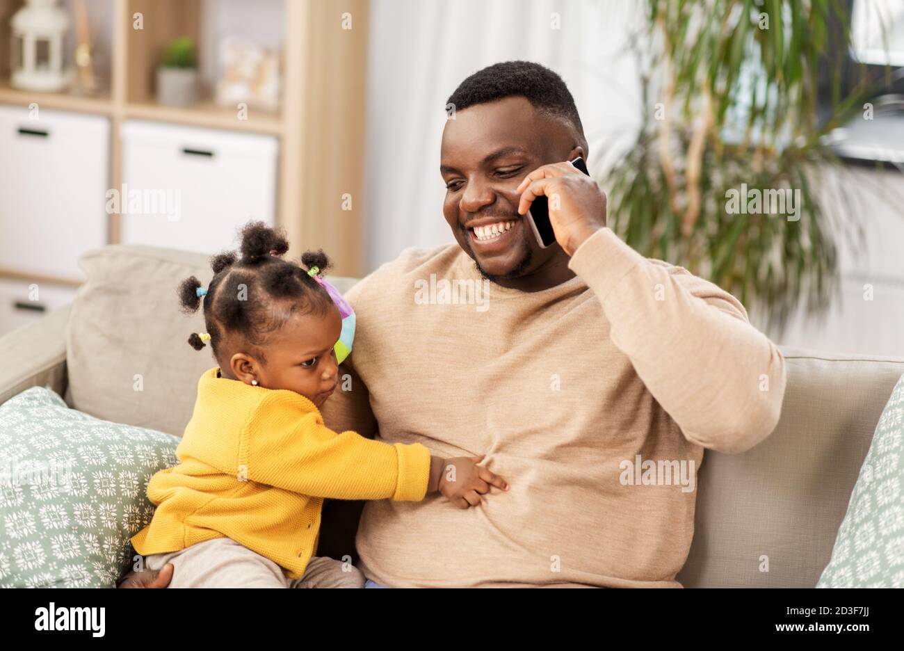 father with baby at home calling on smartphone Stock Photo - Alamy