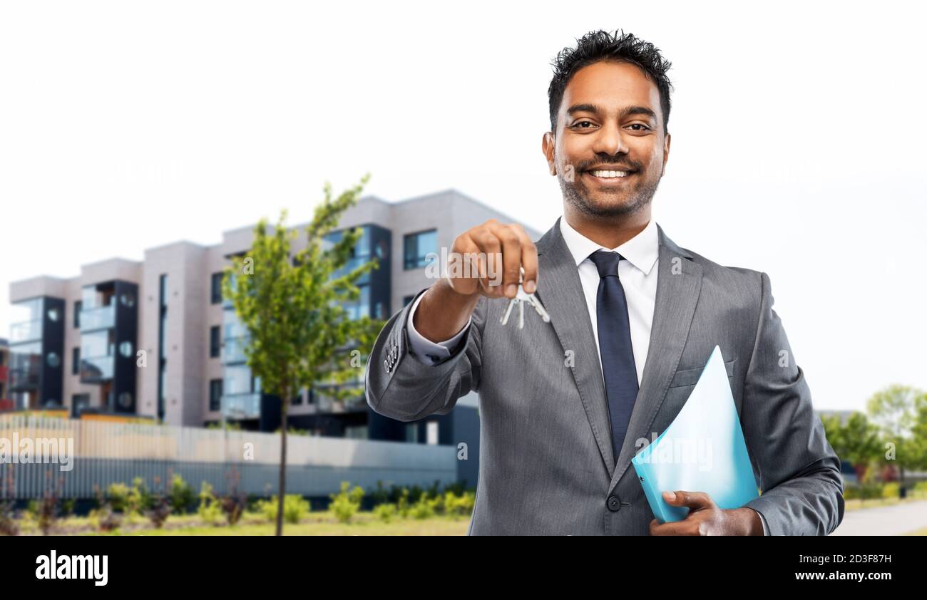 indian man realtor with home keys on city street Stock Photo - Alamy