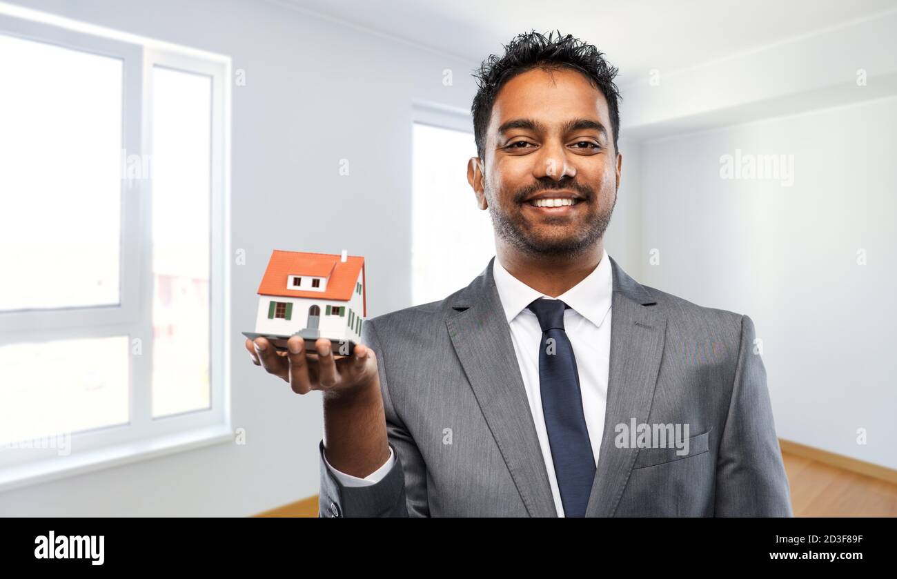 indian man realtor with house model at new home Stock Photo - Alamy