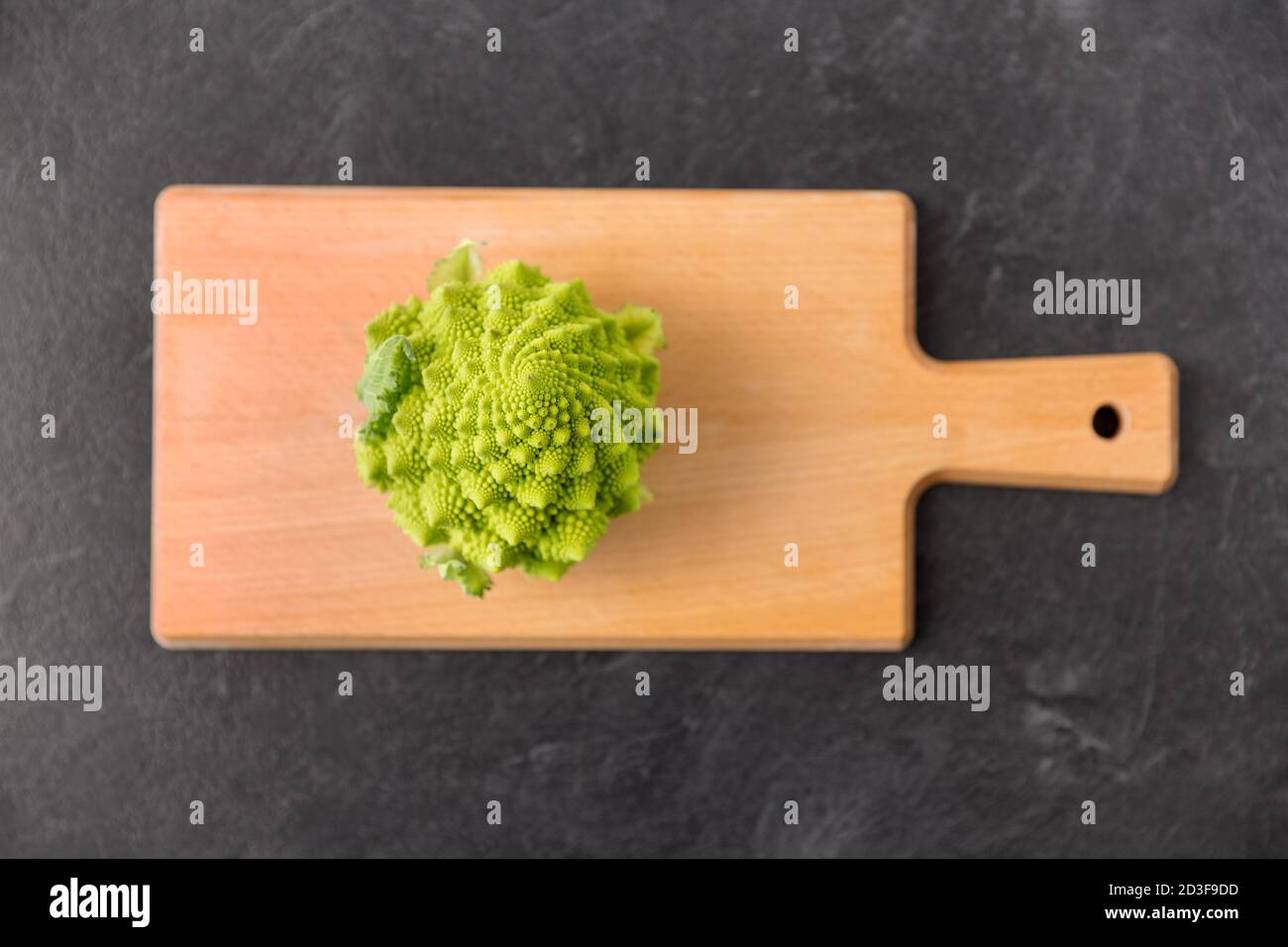 romanesco broccoli on wooden cutting board Stock Photo - Alamy