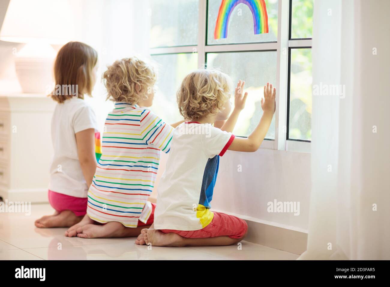 Coronavirus quarantine. Stay home. Kids sitting at window. Children ...