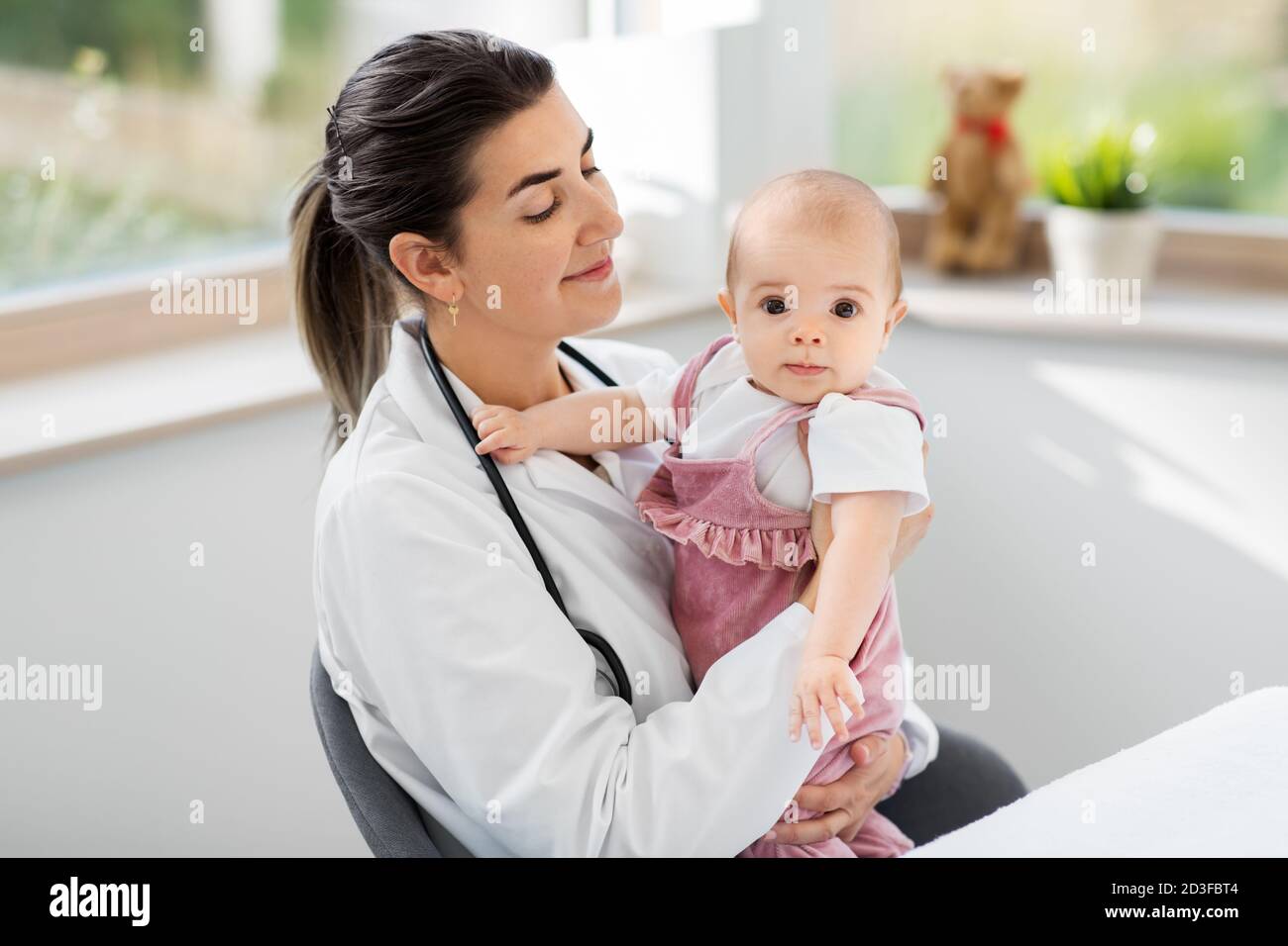 female pediatrician doctor with baby at clinic Stock Photo - Alamy