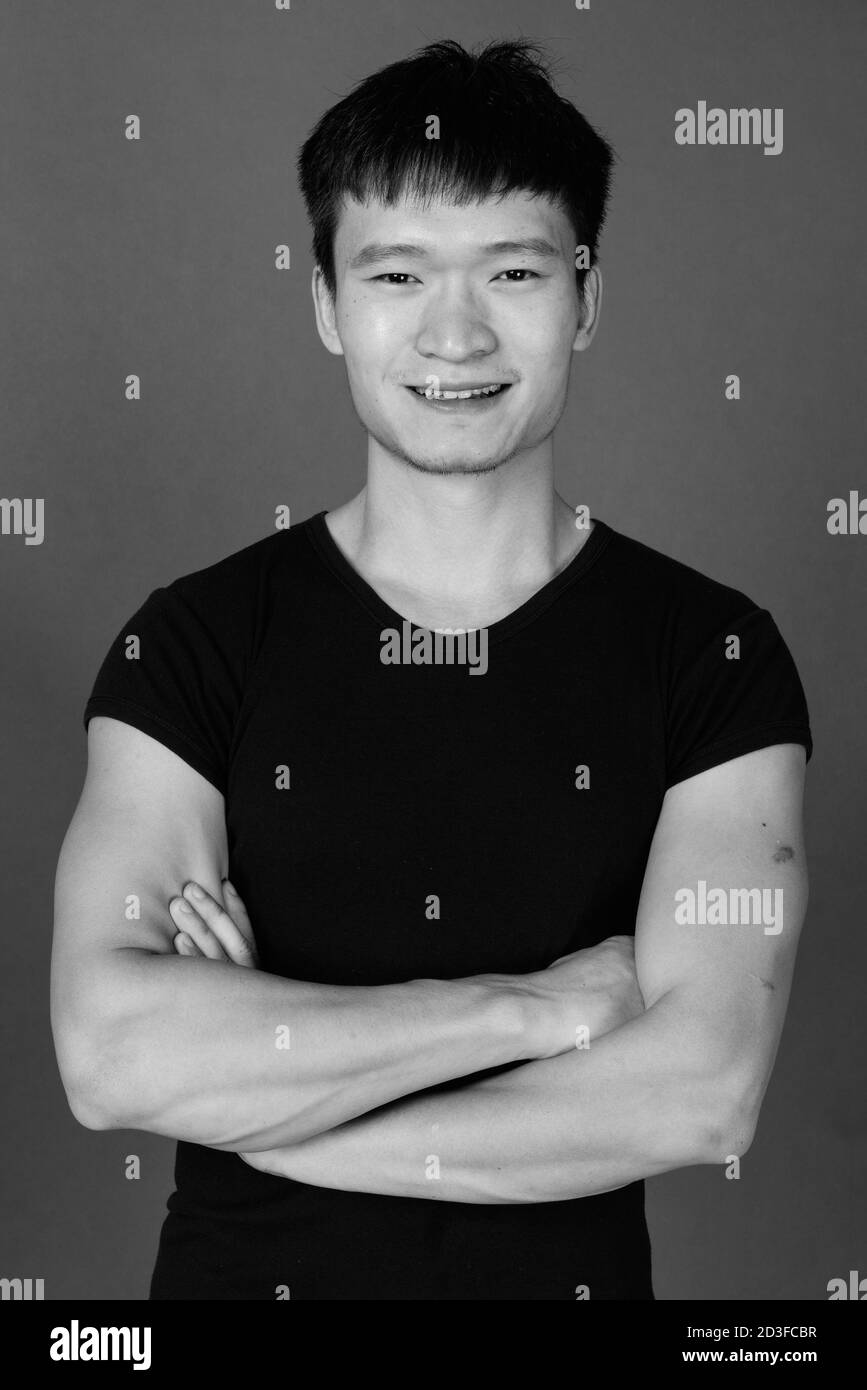 Portrait young chinese man arms crossed Black and White Stock Photos ...