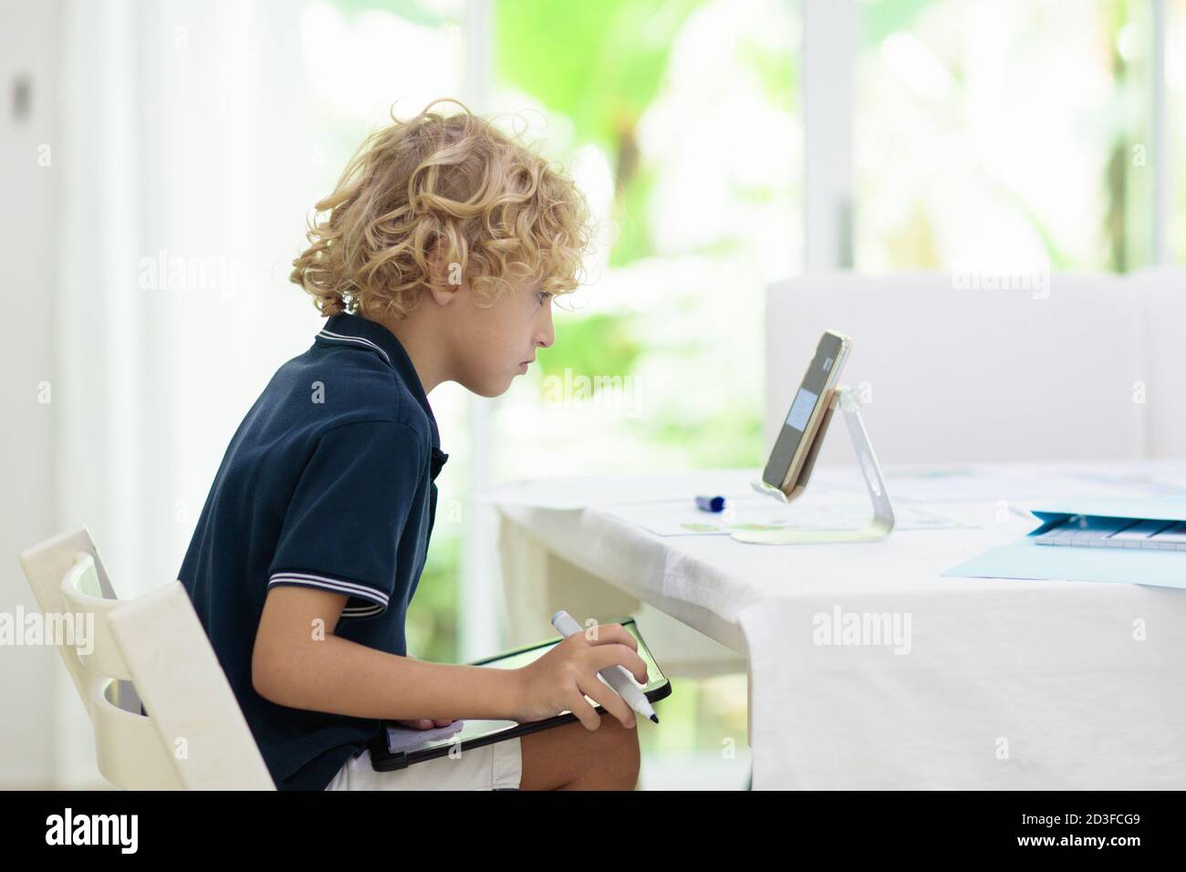 Online remote learning. School kids with computer having video ...