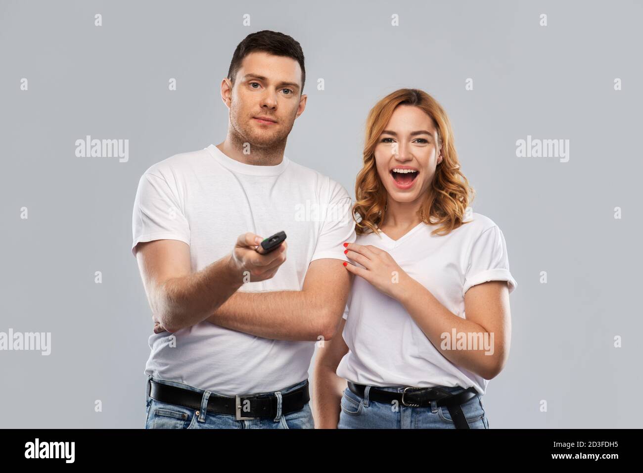 couple with tv remote control Stock Photo - Alamy