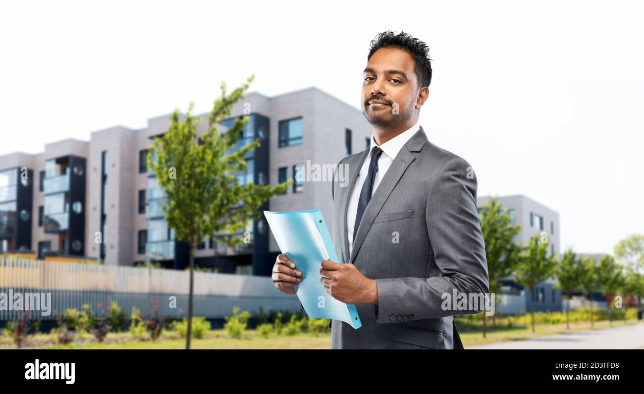 indian man realtor with folder on city street Stock Photo - Alamy