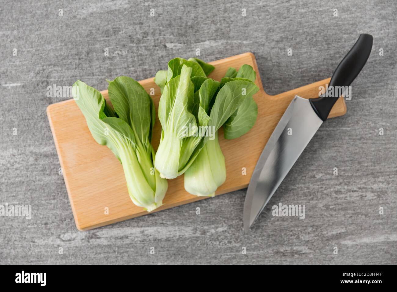 bok choy cabbage and knife on cutting board Stock Photo - Alamy