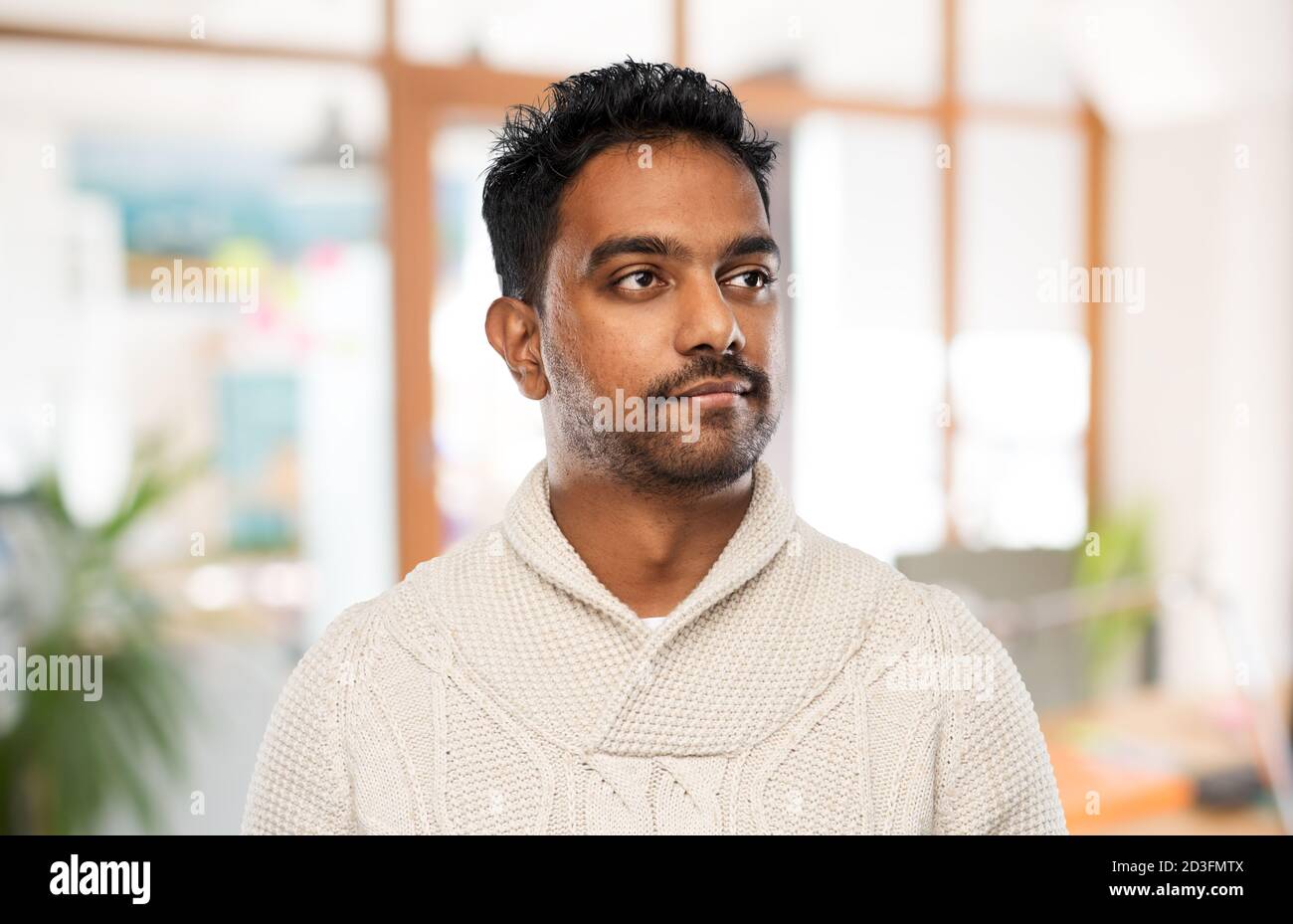 indian man in sweater over office background Stock Photo - Alamy