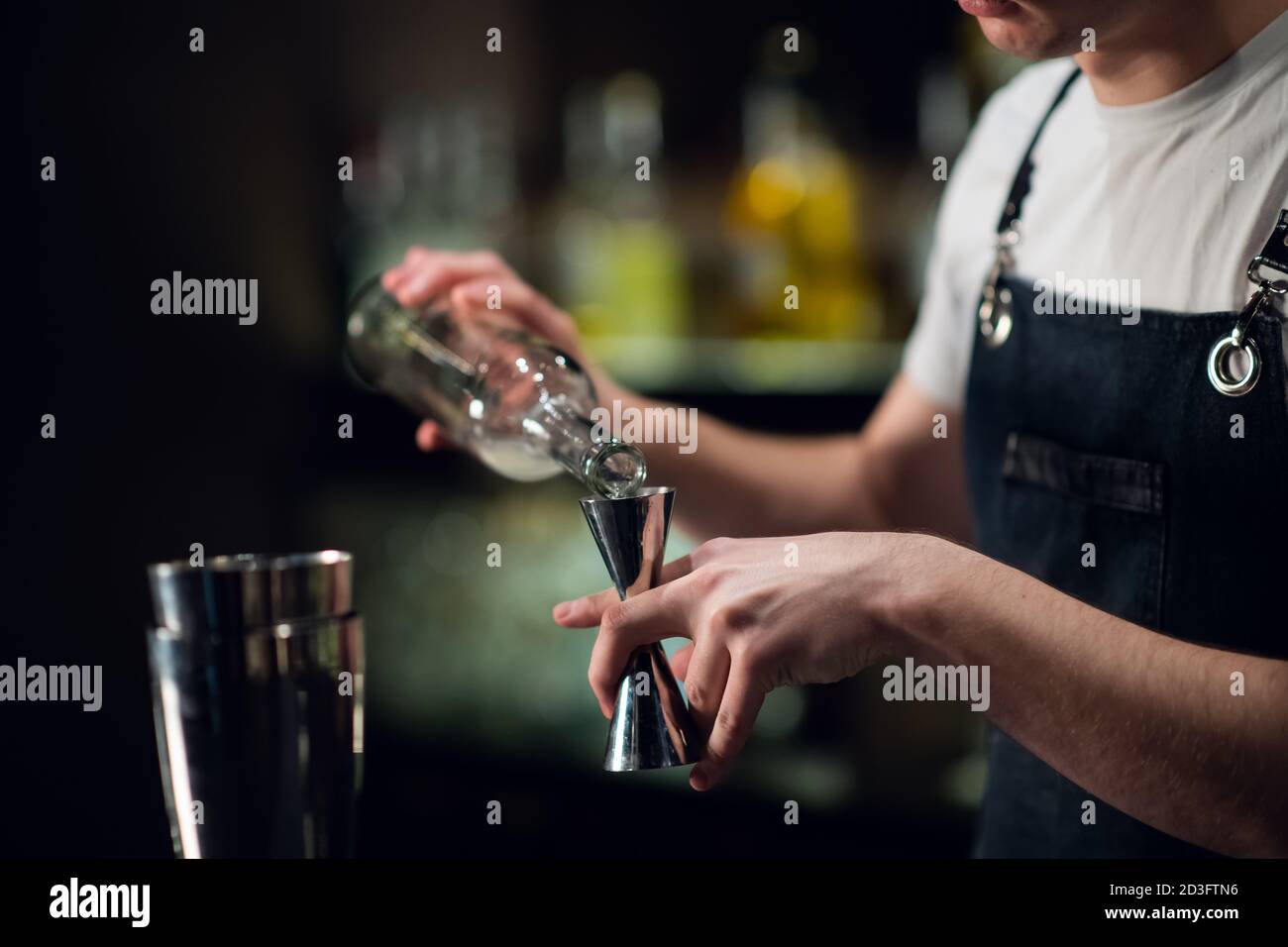 Close-up of the process of preparing a cocktail with liqueur at a party ...
