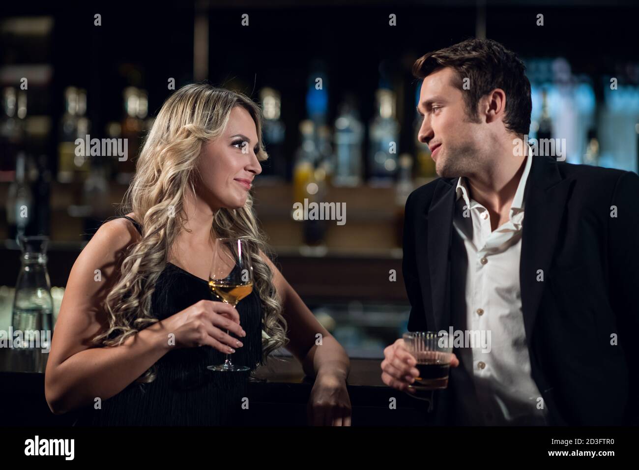 beautiful man and woman at the bar drinking cocktails Stock Photo - Alamy