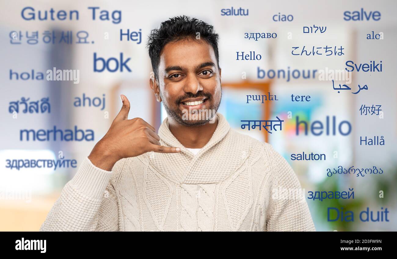 indian man in sweater making phone call gesture Stock Photo - Alamy