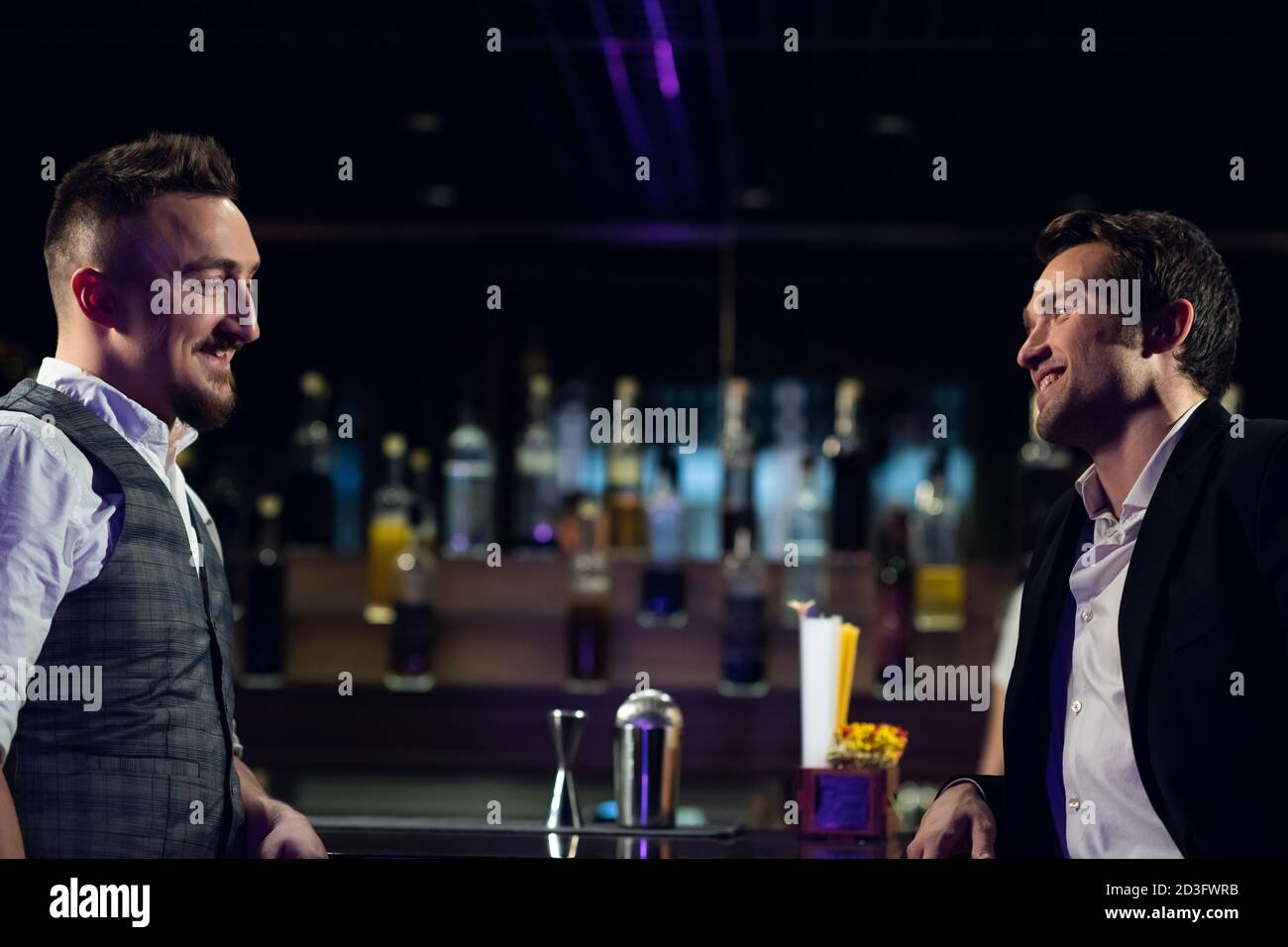 two male friends meet at the bar at the counter and communicate Stock ...